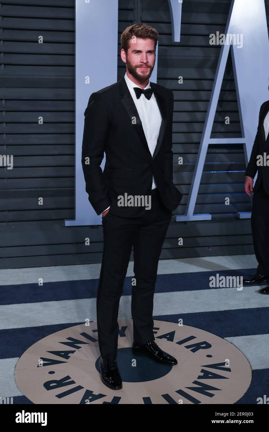 Liam Hemsworth walking on the red carpet at the 2018 Vanity Fair Oscar ...