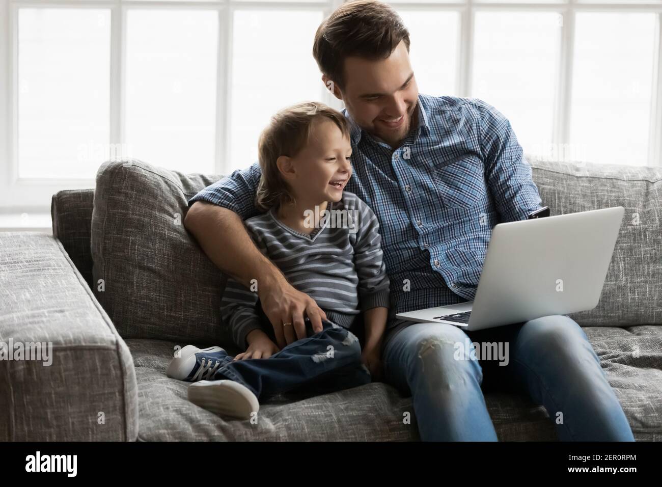Happy daddy and adorable gen Z boy sitting together Stock Photo - Alamy