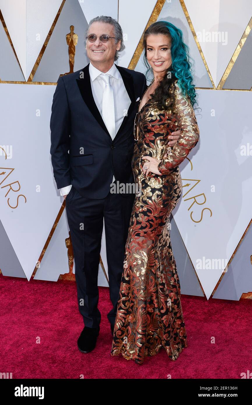 Mark Mangini and Ann Mangini walking on the red carpet during the 90th ...