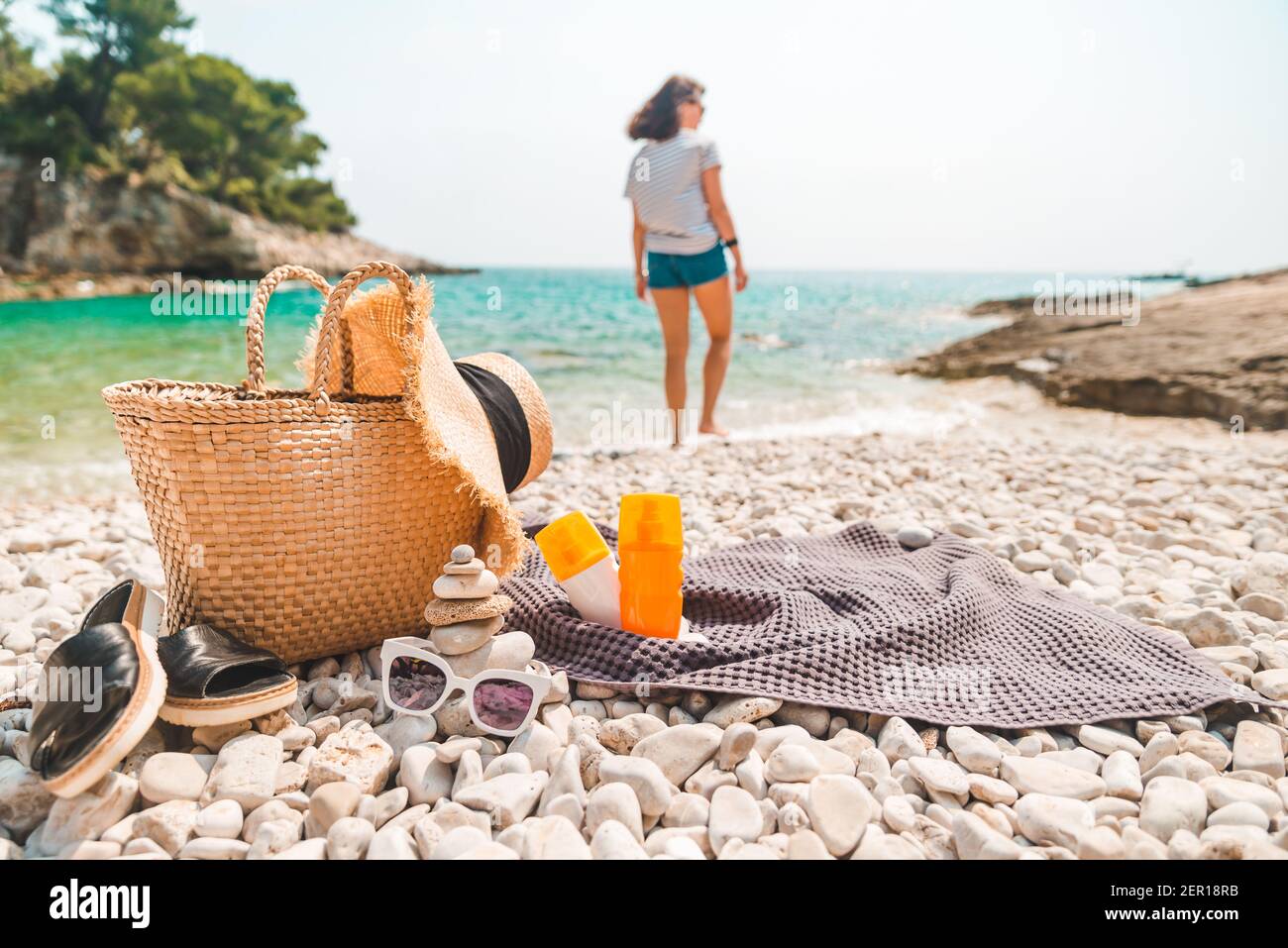 beach stuff straw hat and bag with flippers and sun protection cream at ...