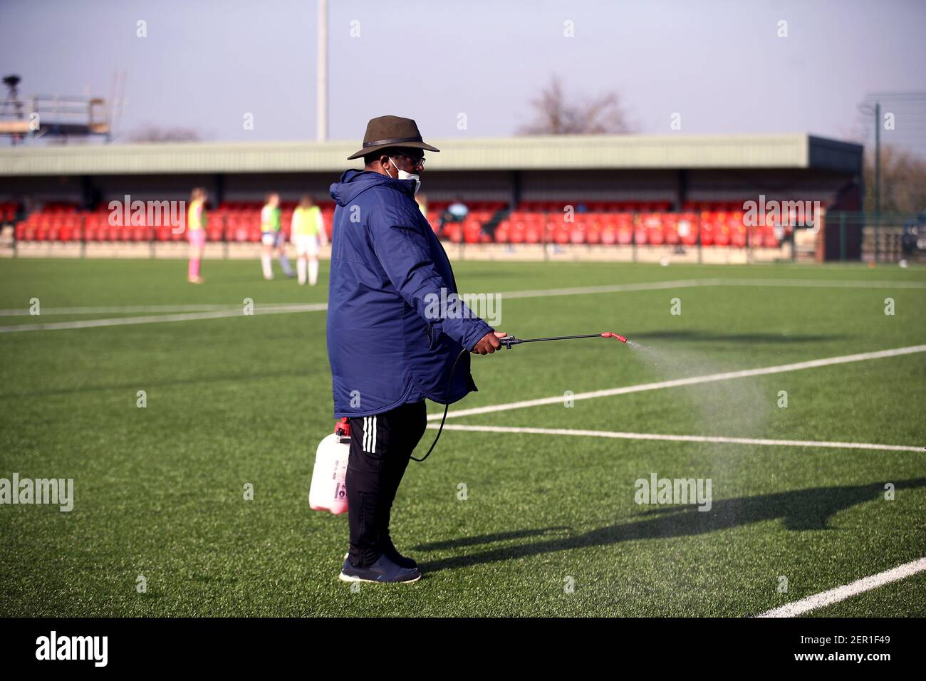 A member of the ground staff sprays the pitch at half time of the FA ...