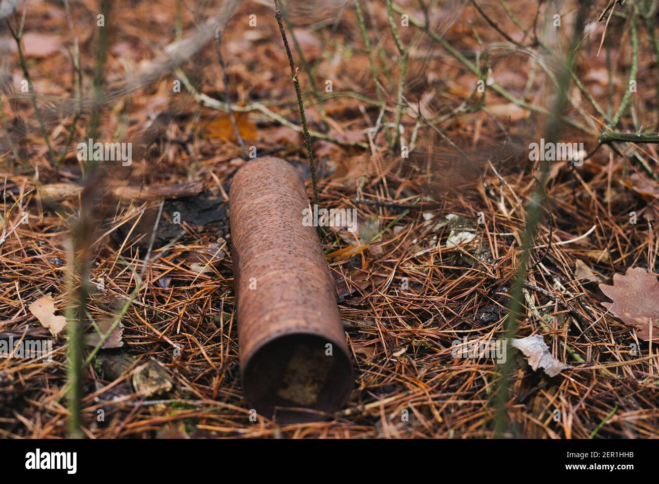 An old rusty can of construction foam lies thrown away in the forest ...