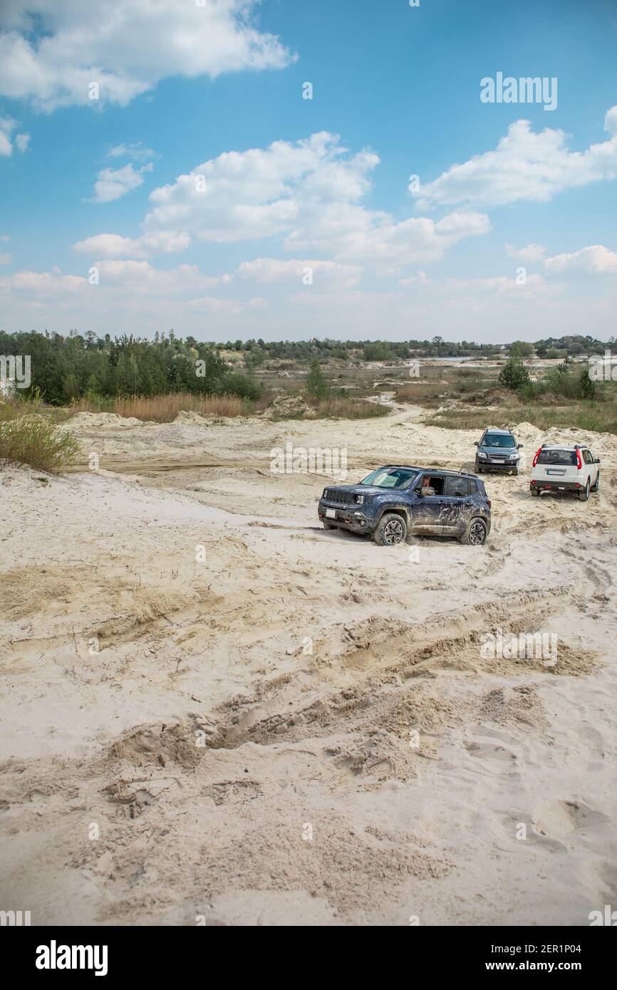 suv cars overcoming sand barrier. off road concept Stock Photo - Alamy