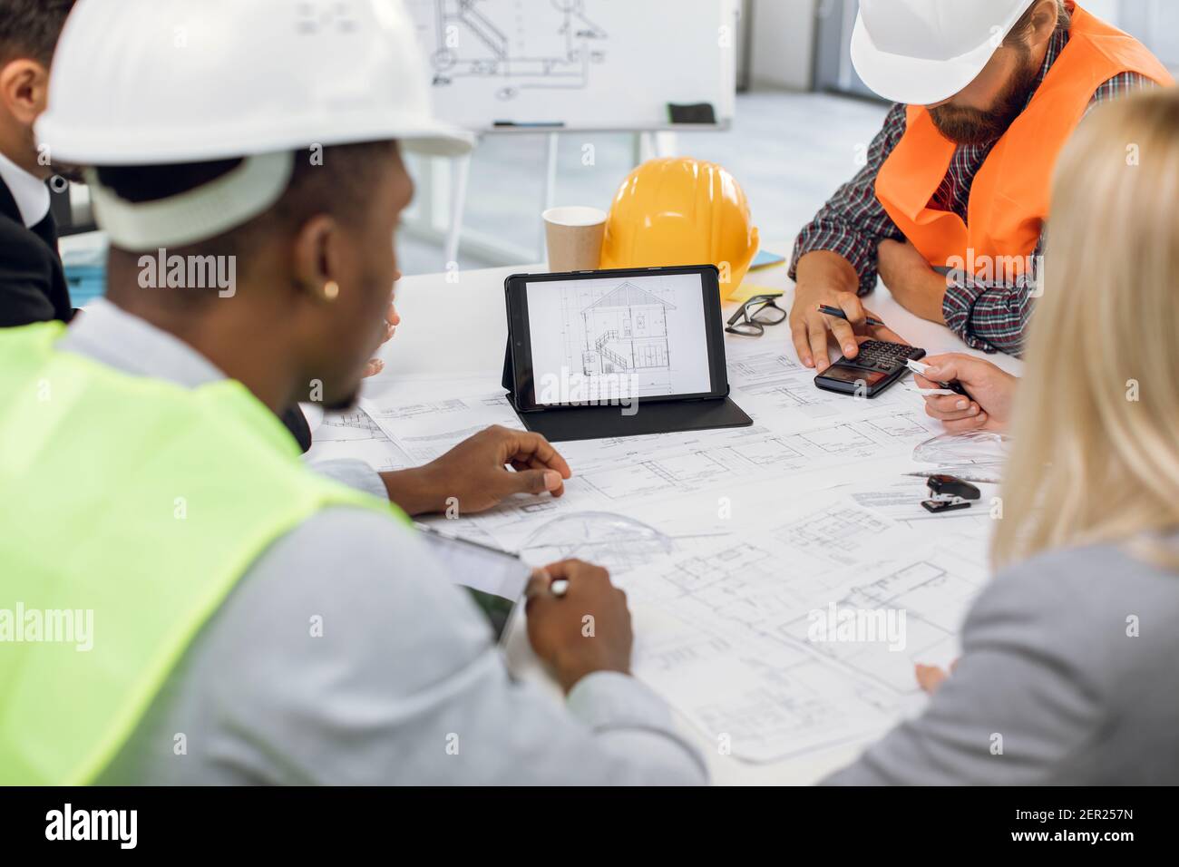 Workers using gadgets for creating plan of construction Stock Photo - Alamy