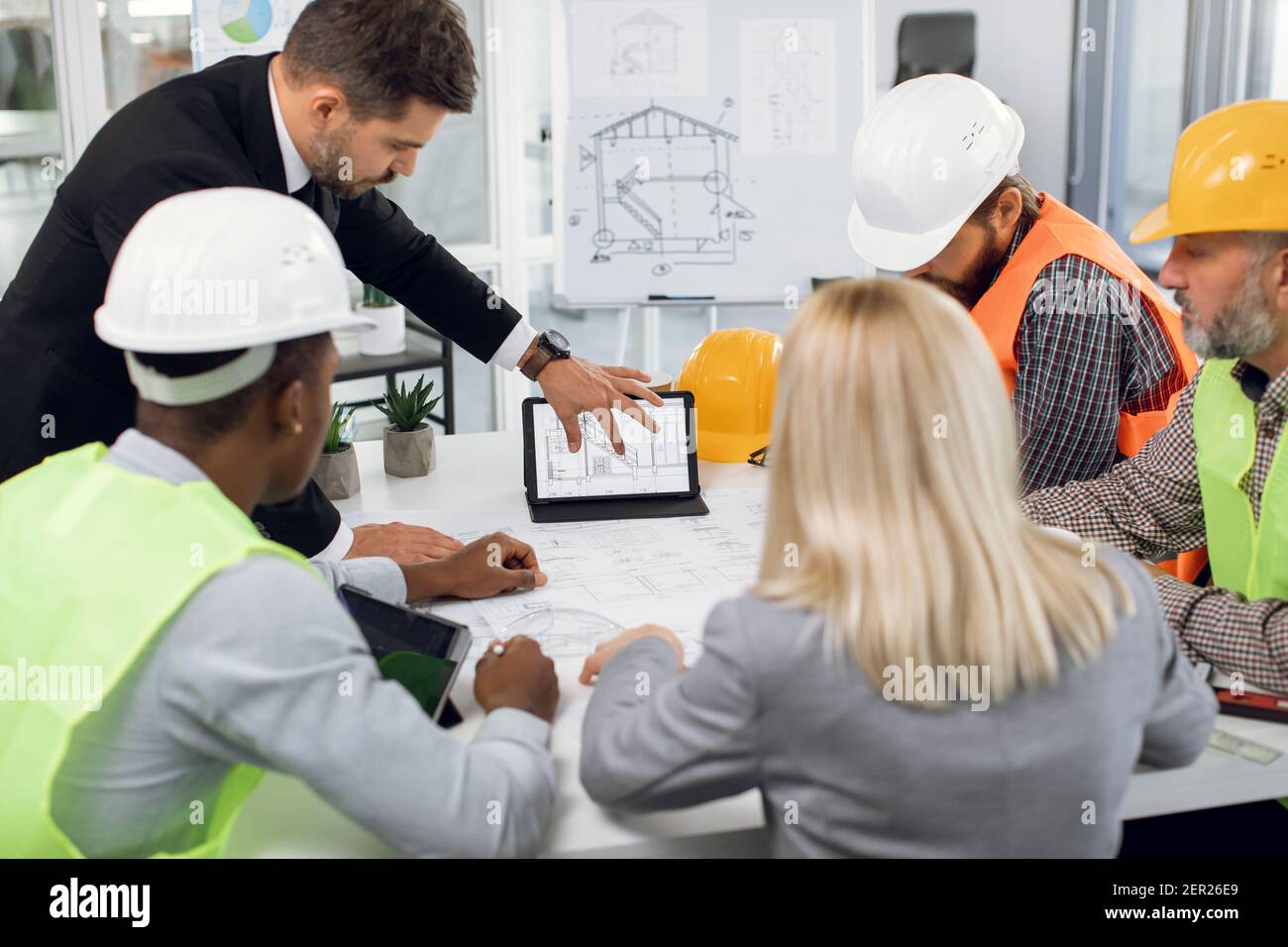 Multiethnic professional team of engineers and managers, brainstorming together over ...