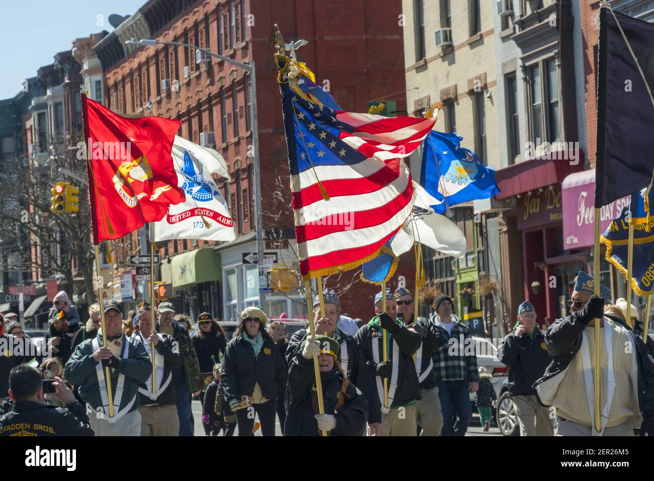Veterans from branches of the military carry flags as they celebrate St ...