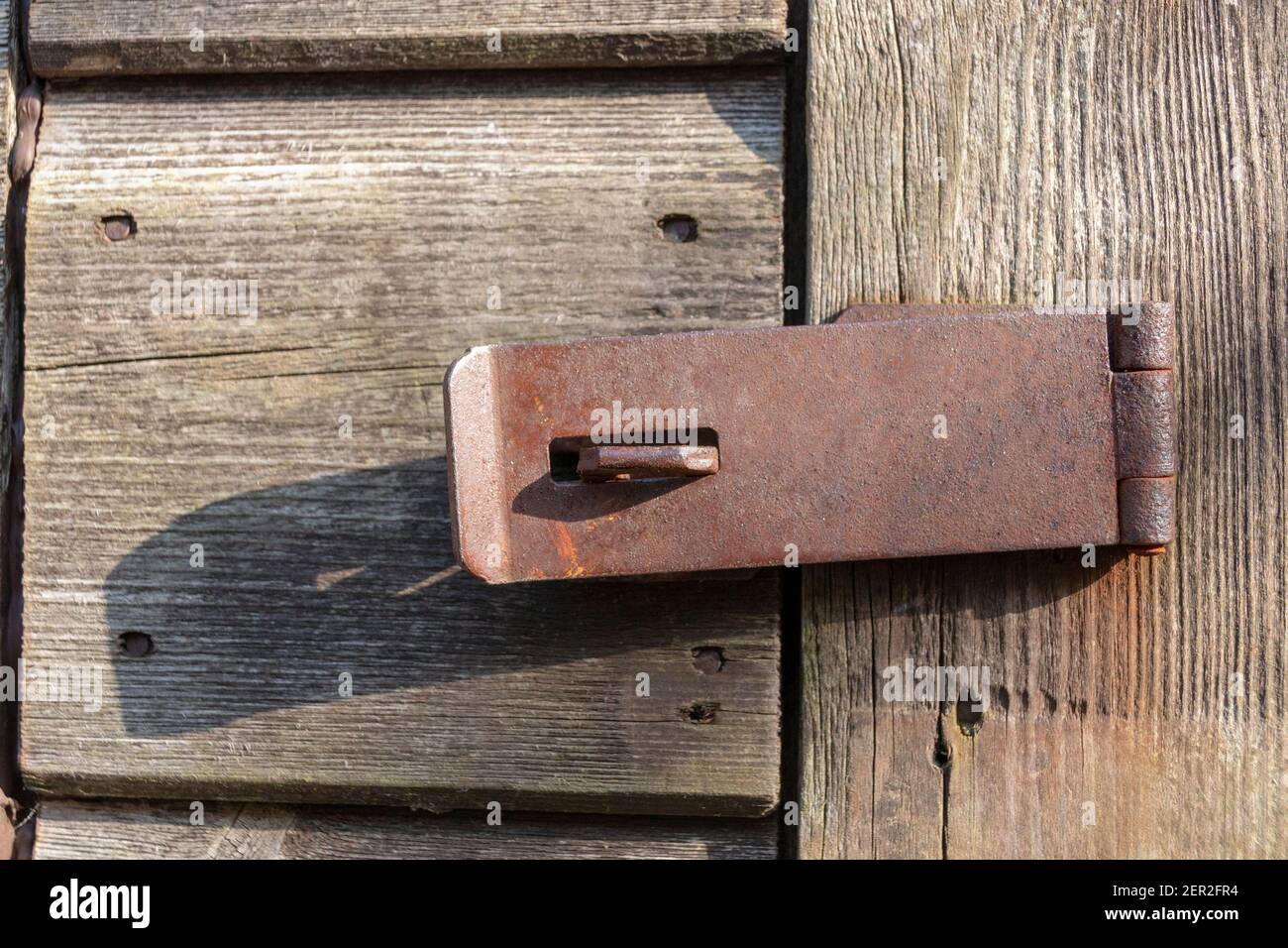 a close up view of a open lock that keeps this wooden door closed Stock ...