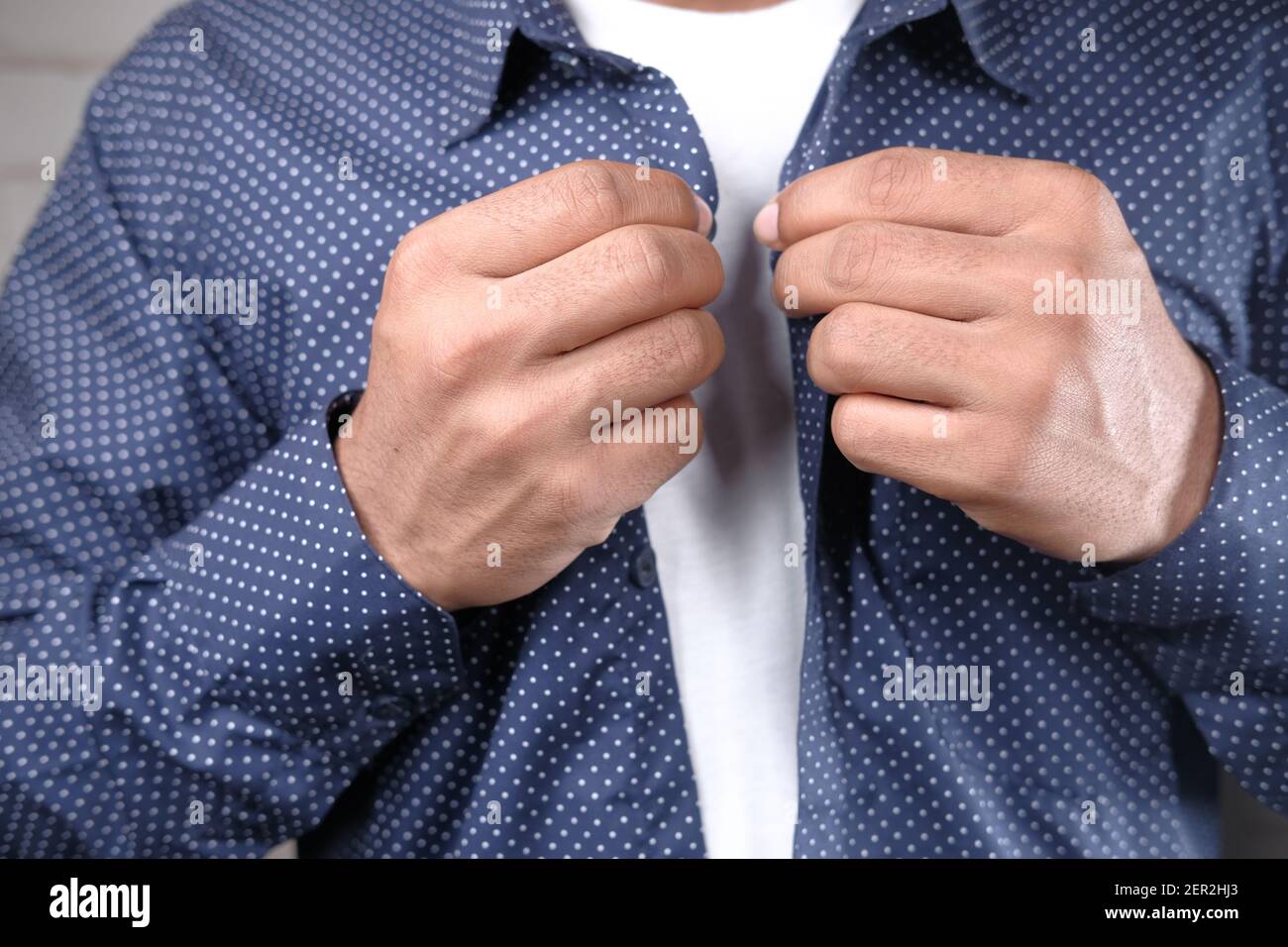 Buttoning his shirt hi-res stock photography and images - Alamy