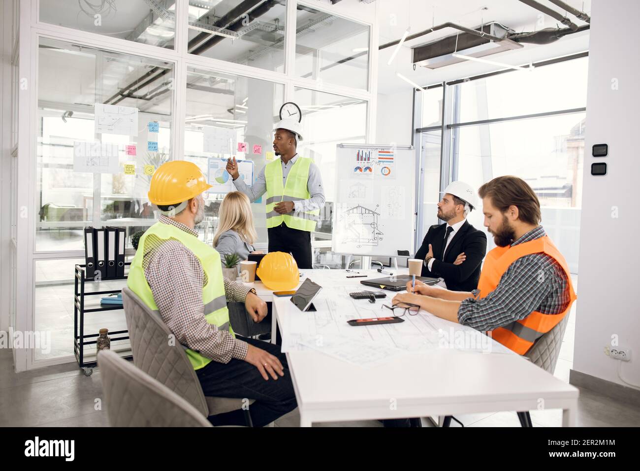 African man presenting construction project to colleagues Stock Photo ...