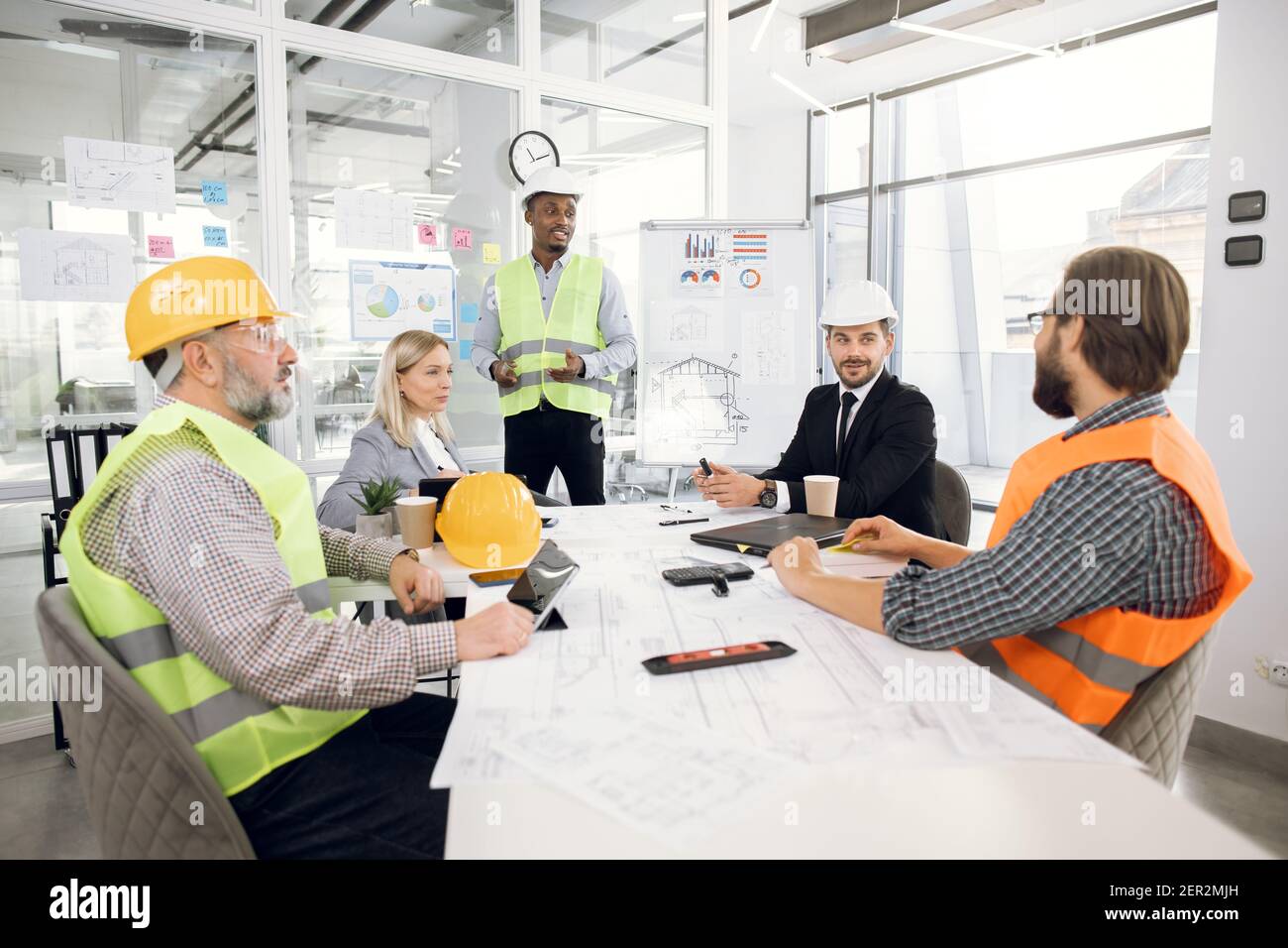African man presenting construction project to colleagues Stock Photo ...