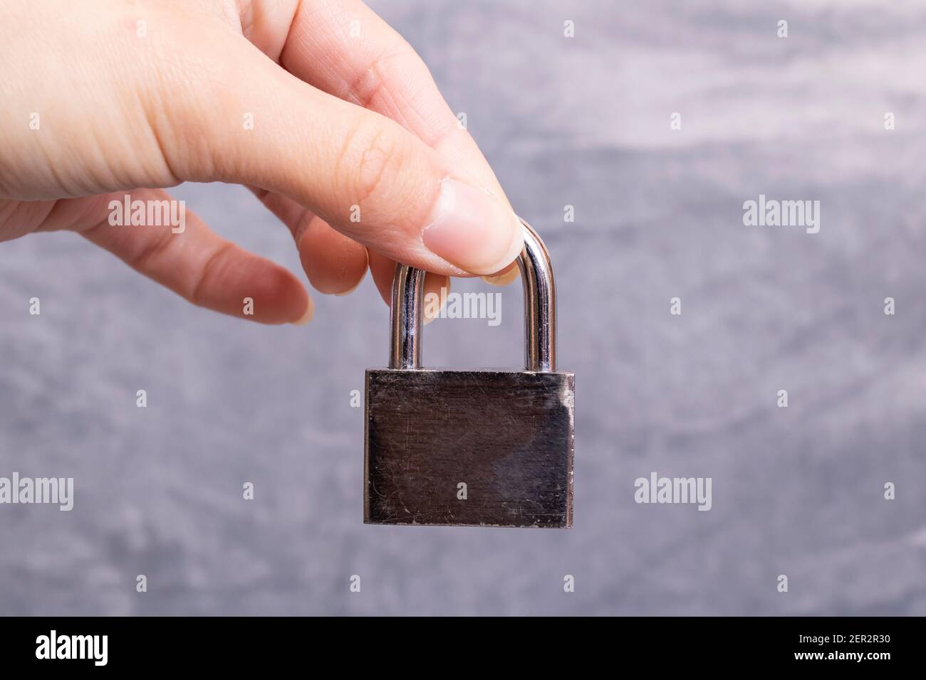 Metal padlock in hand hi-res stock photography and images - Alamy