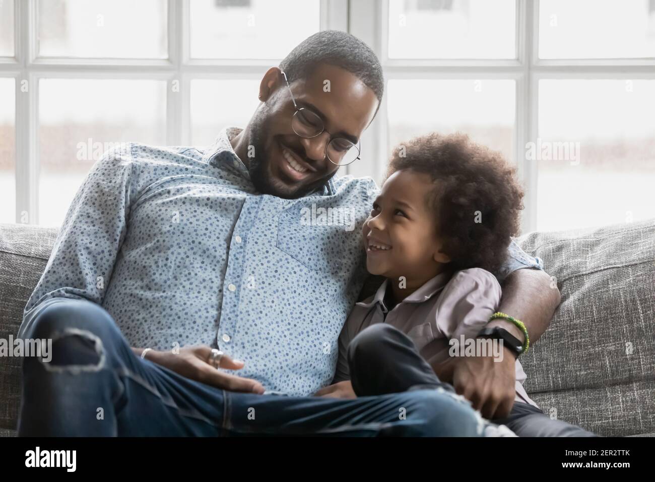 Happy Black father enjoying leisure time with little son Stock Photo ...