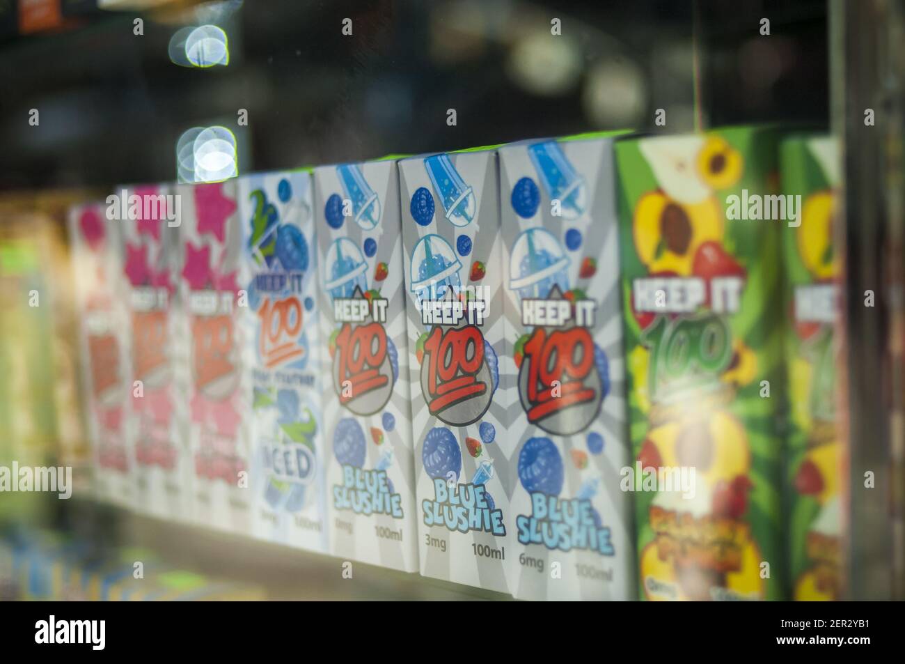 A selection of flavored vaping supplies on display in the window of a ...