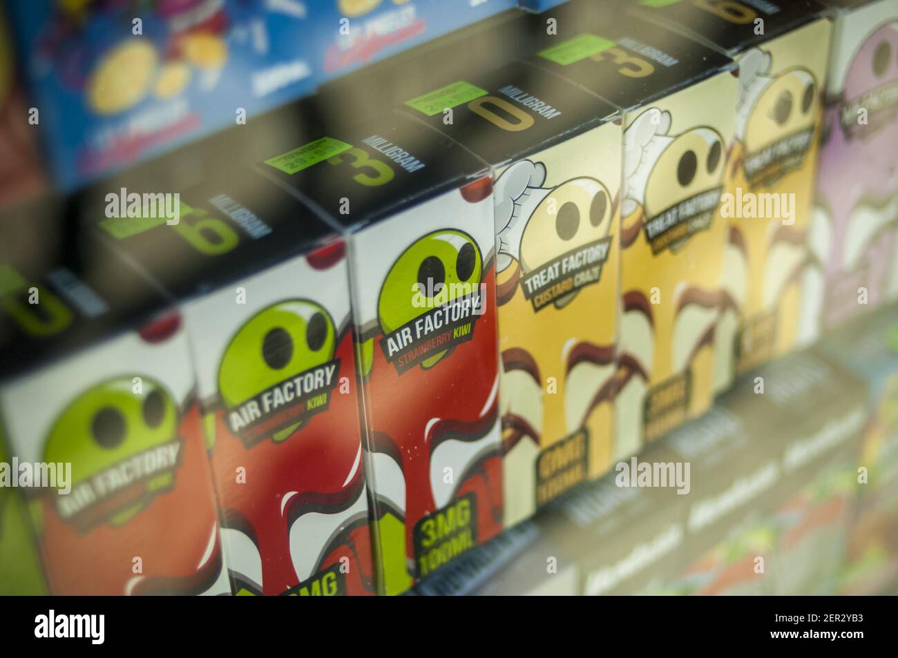 A selection of flavored vaping supplies on display in the window of a ...