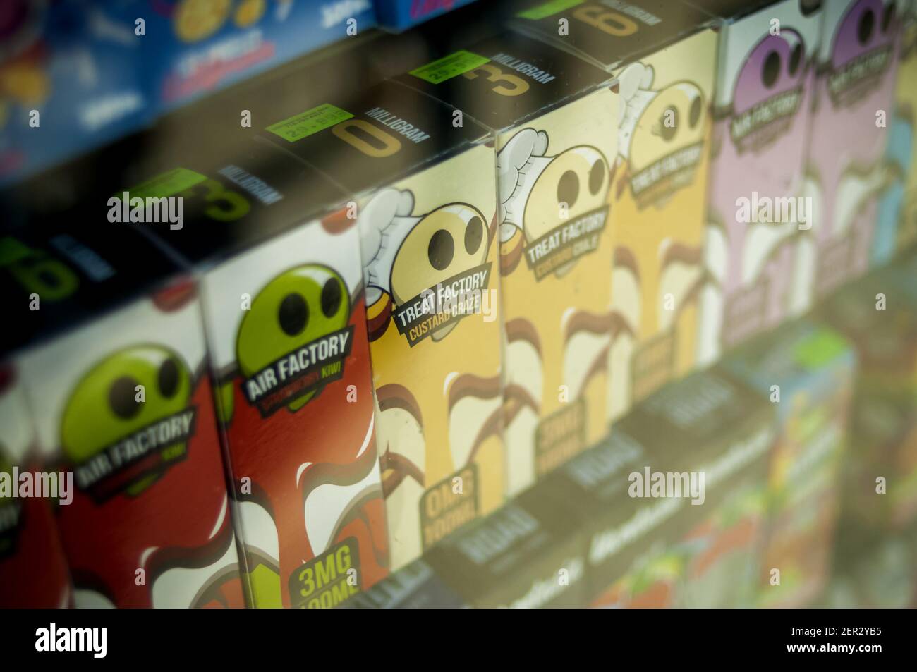 A selection of flavored vaping supplies on display in the window of a ...