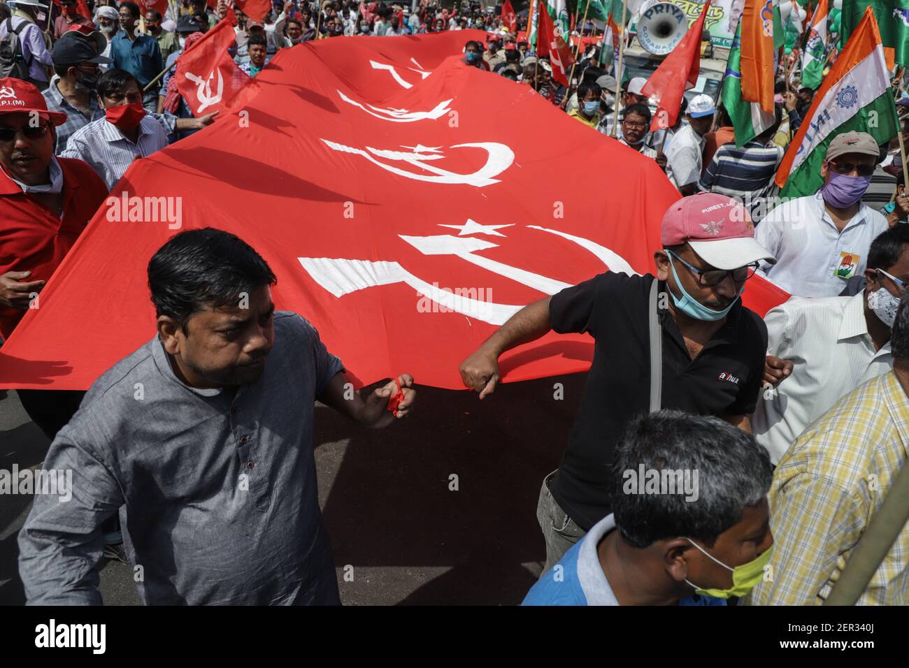 CPIM (Communist Party of India Marxist) party supporters marching with ...