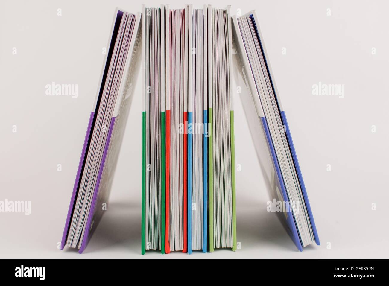 a new books of different colors on white background Stock Photo - Alamy