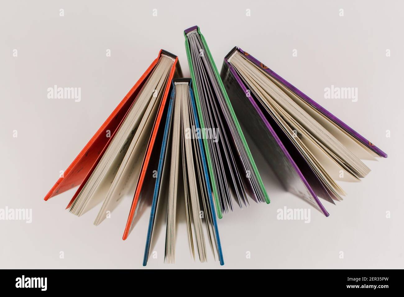 a new books of different colors on white background Stock Photo - Alamy