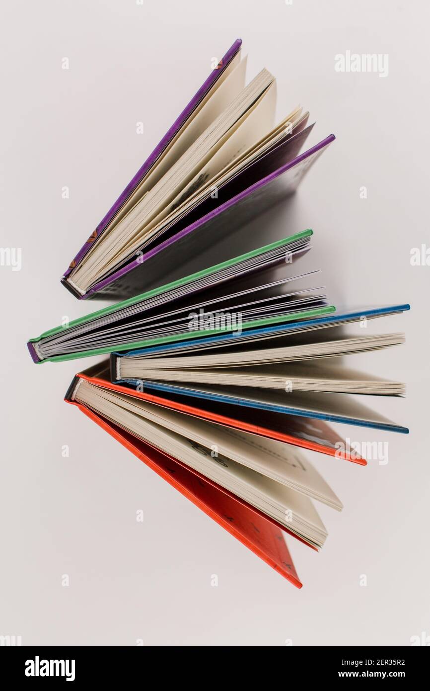 a new books of different colors on white background Stock Photo - Alamy
