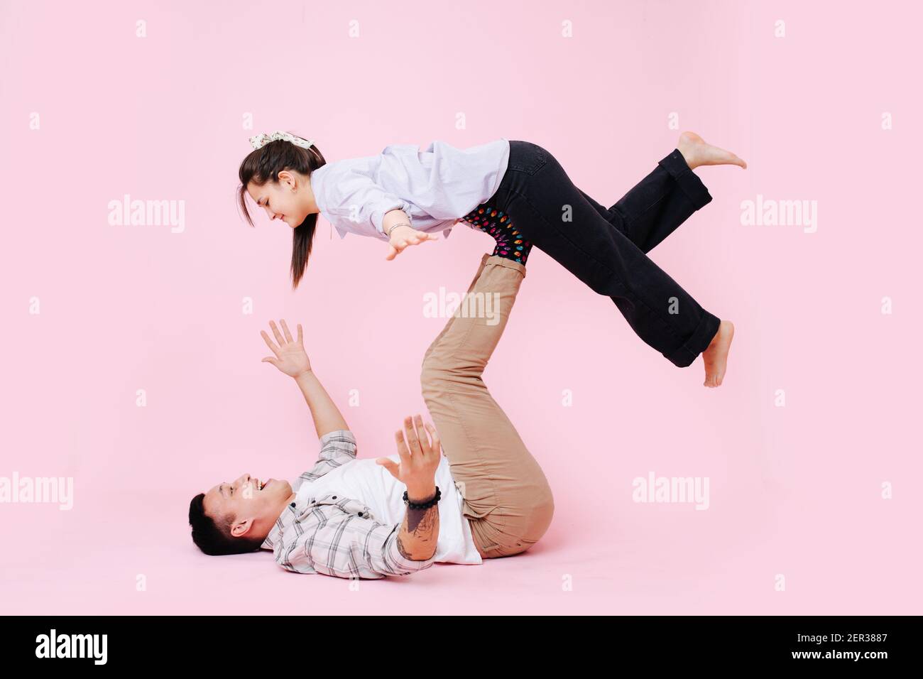 A man lifts a woman on her feet while she holds the balance. Image on a ...