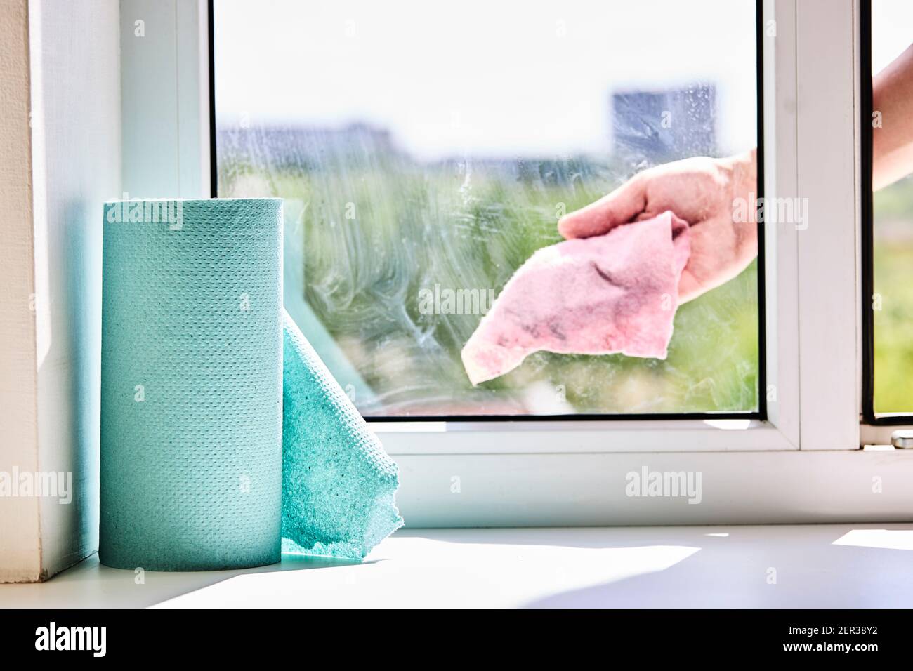 cleaning or washing dirty domestic window with a chemical spray ...