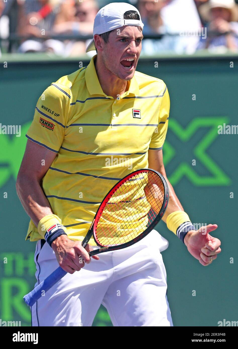 John Isner celebrates after a point as he plays Alexander Zverev in ...
