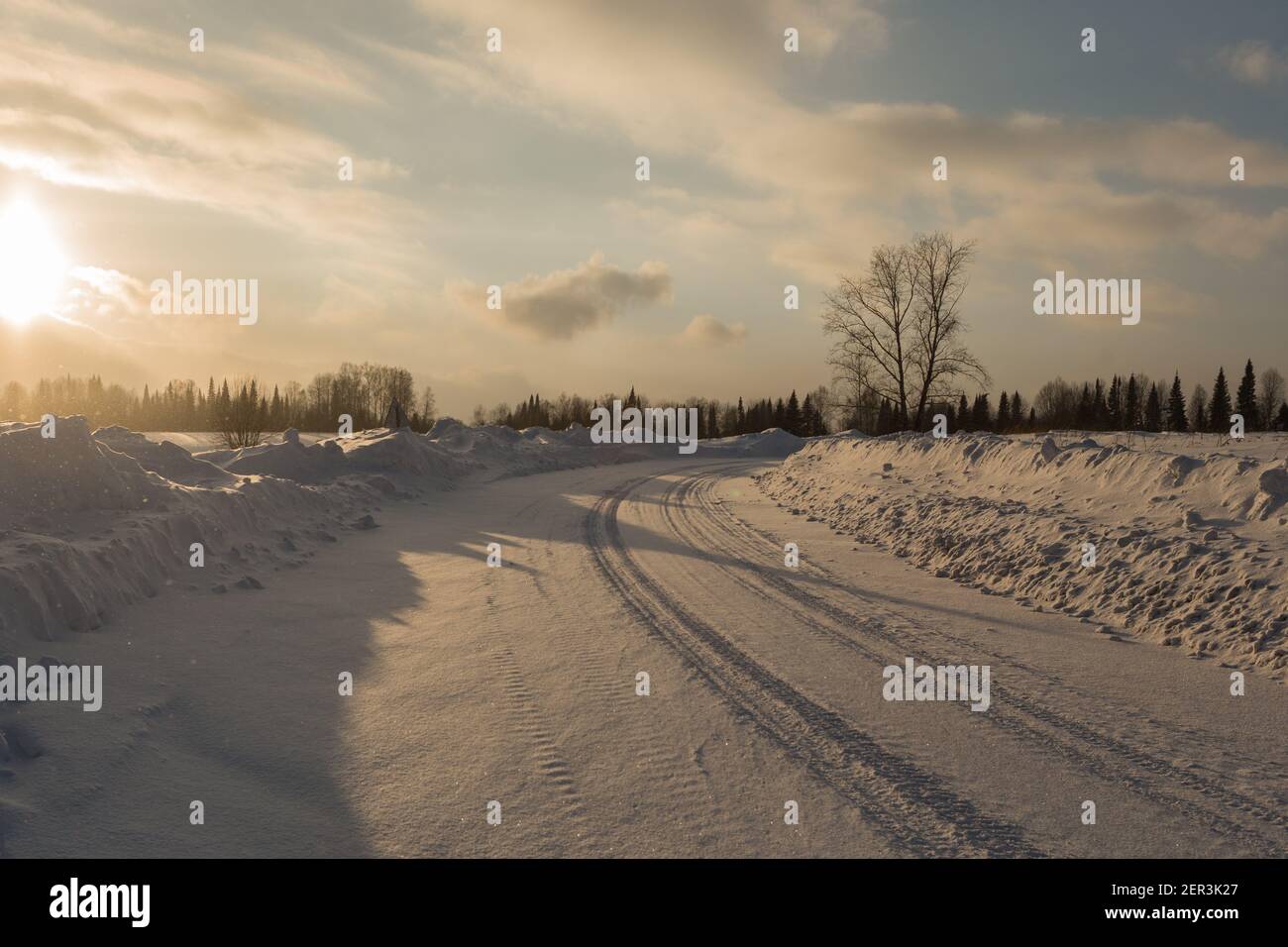 Empty snow covered road in winter landscape Stock Photo - Alamy