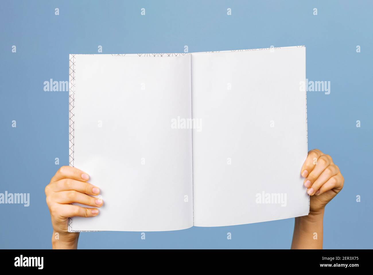 Hands holding blank open notebook over gray background. Empty book ...