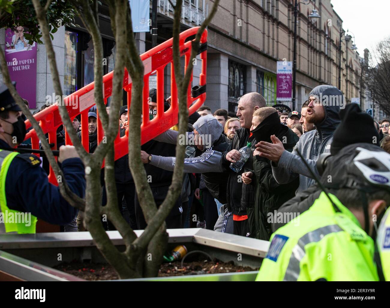 A protestor throws a plastic barrier at Garda on Grafton Street in ...