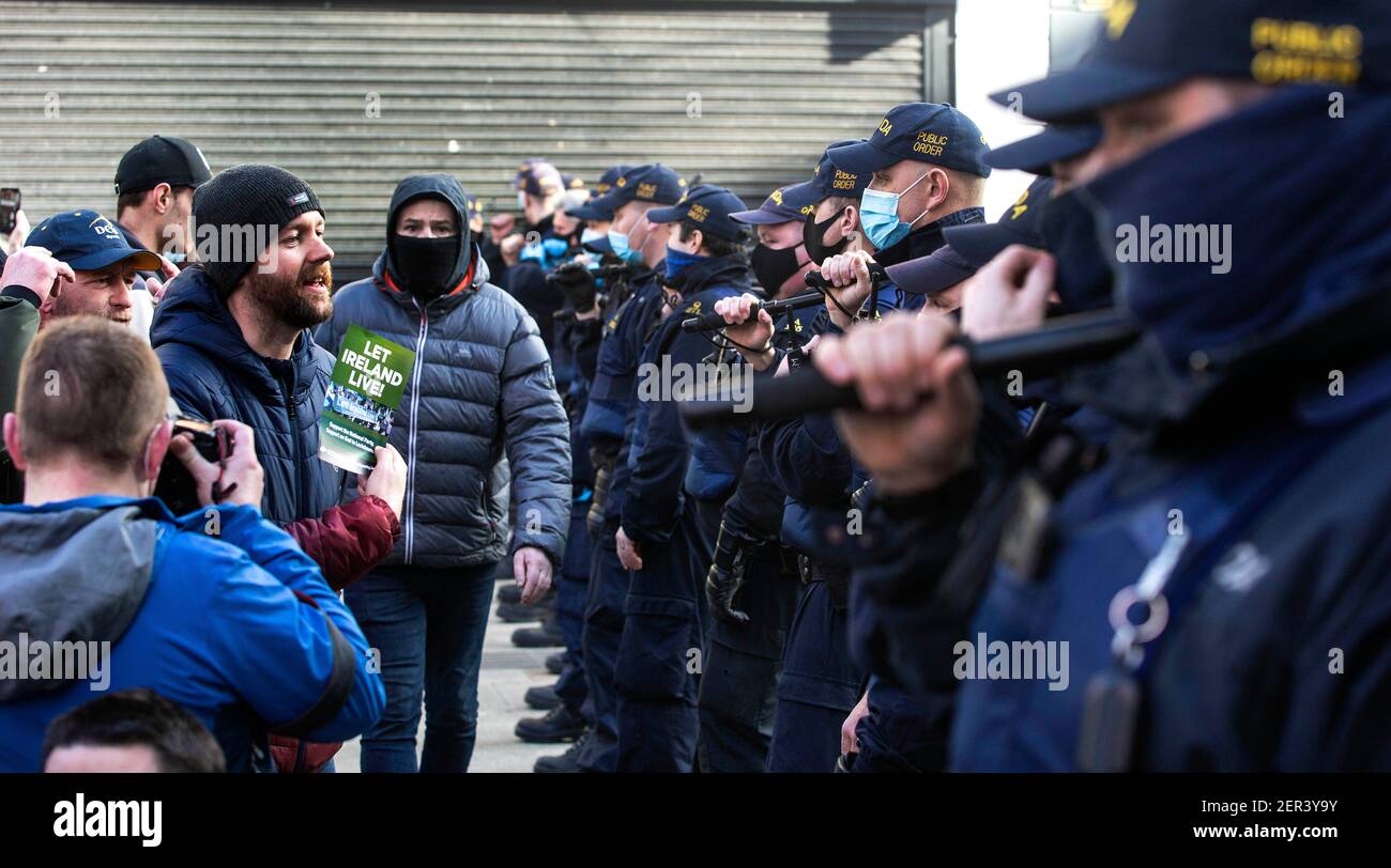 A protestors shows Garda an anti lockdown leaflet on Grafton Street in ...