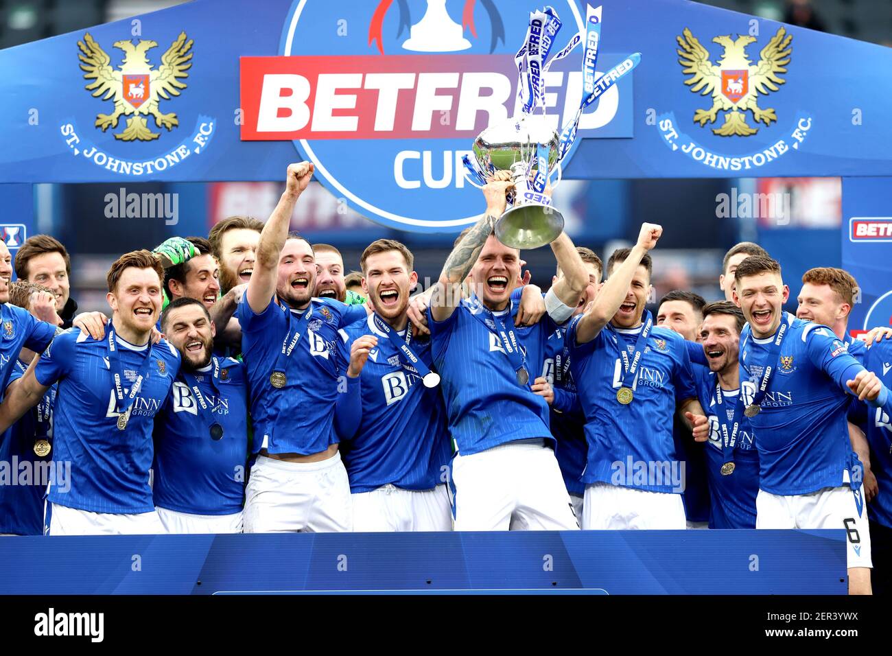 St Johnstone's Jason Kerr (centre) lifts the Betfred Cup trophy as his ...
