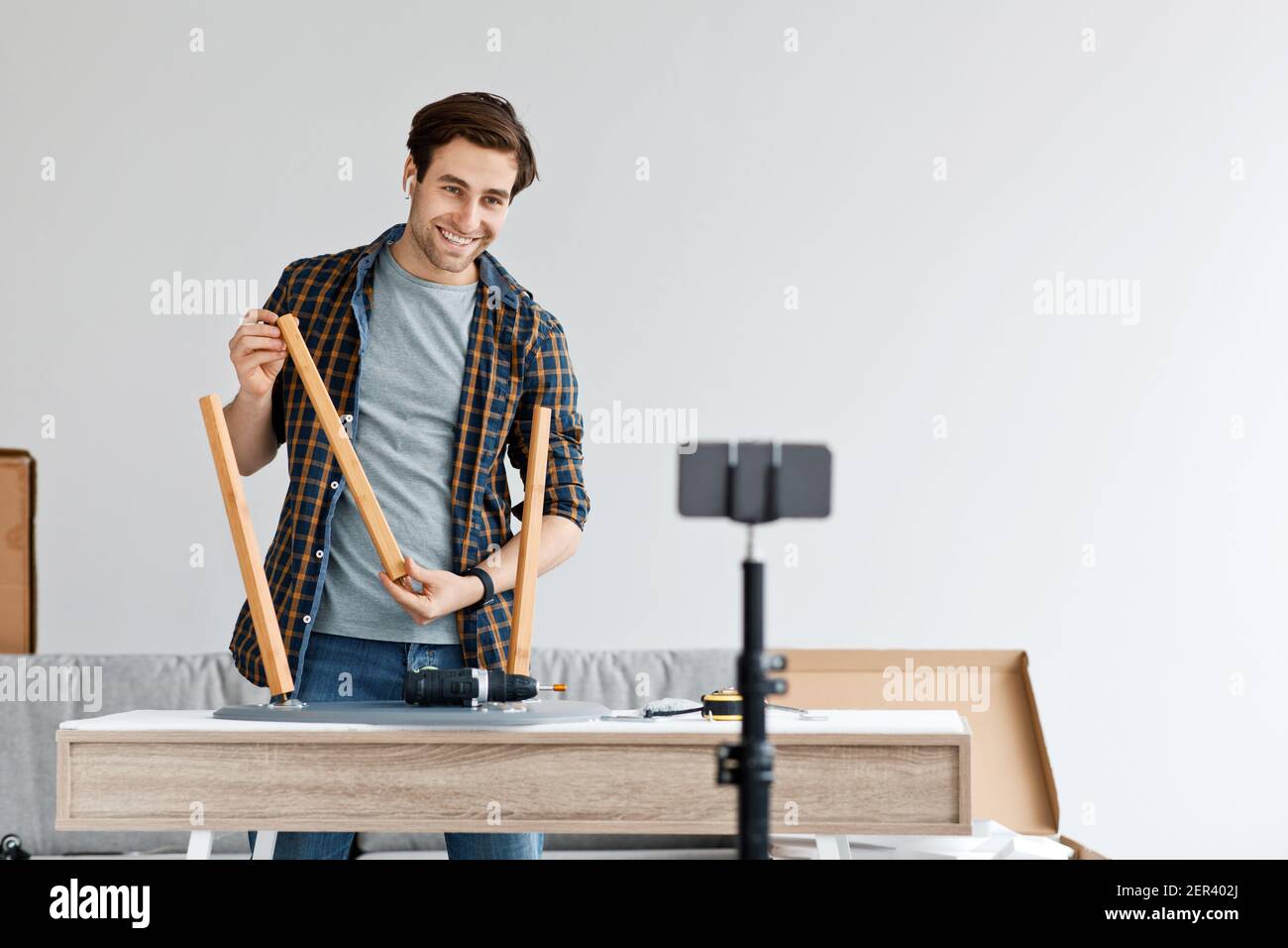 Adjusting or repair chair, worker fixing, assembling wooden stool with ...