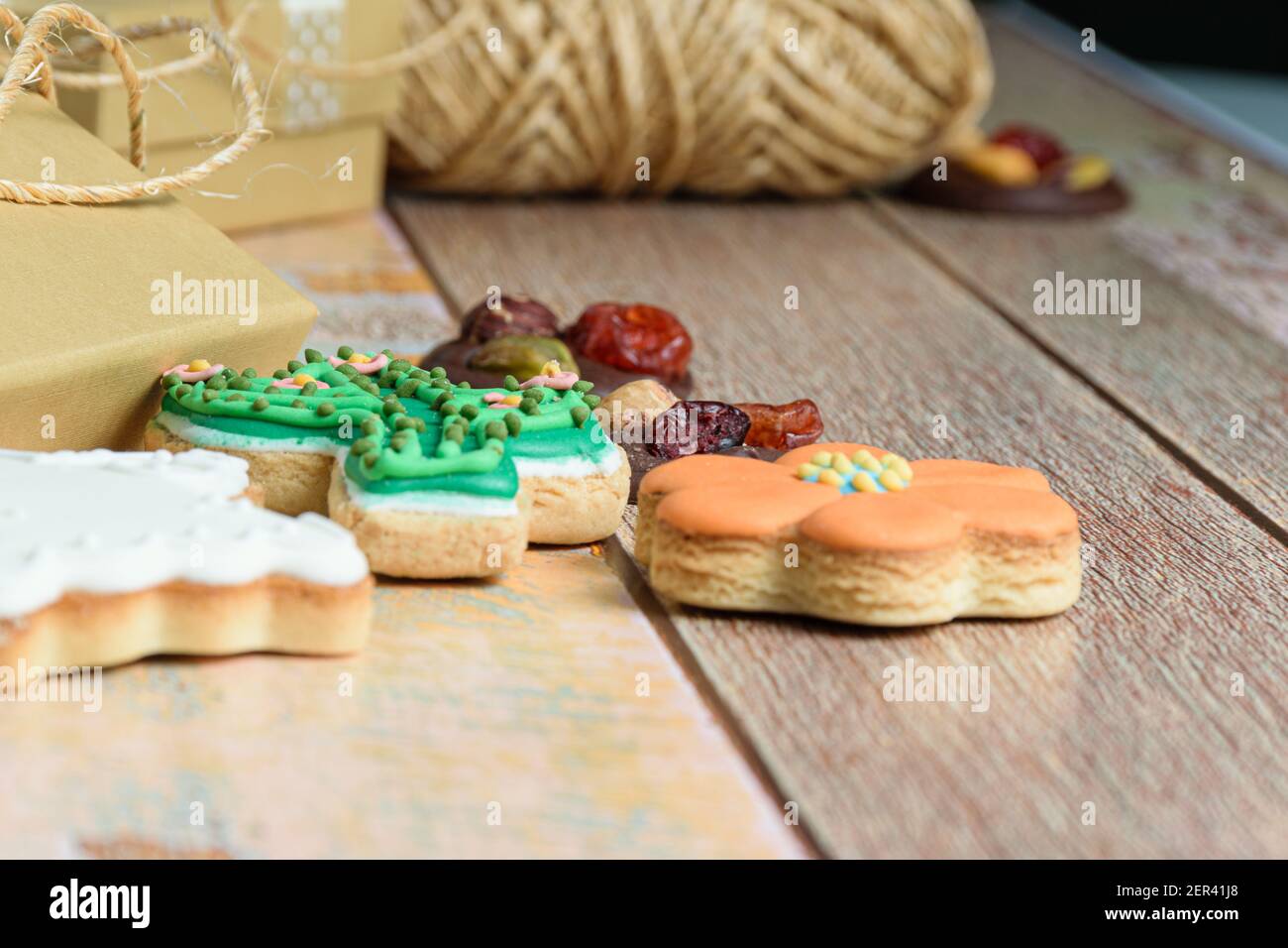 Cookies in various shapes next to a small golden box and a roll of ...