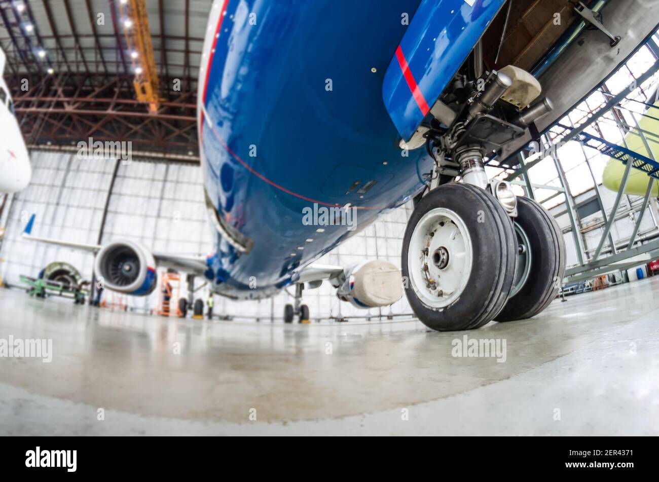 Front chassis rack airplane close-up in focus, background inside hangar ...