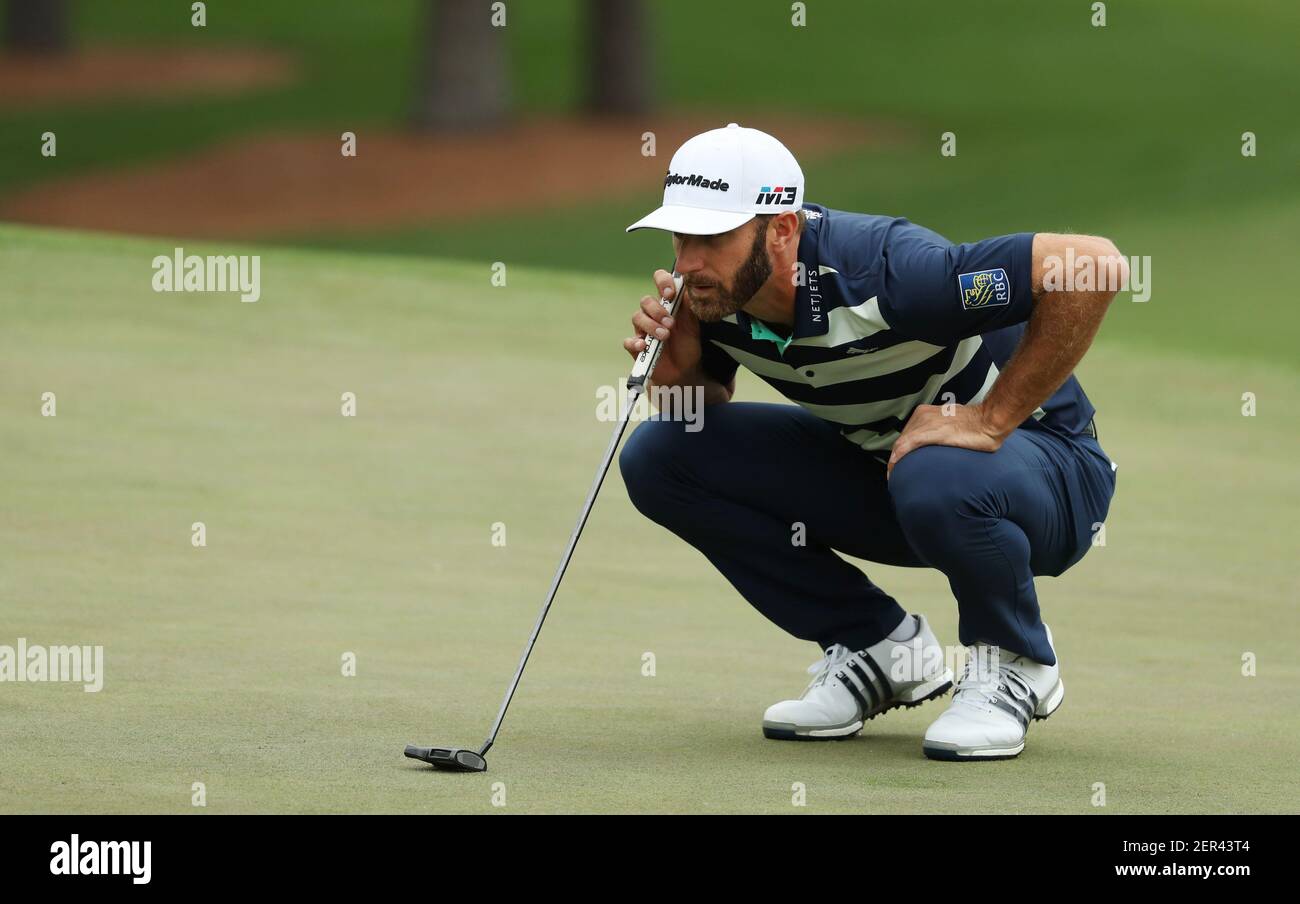 Dustin Johnson lines up a putt on the 7th hole during the third round ...