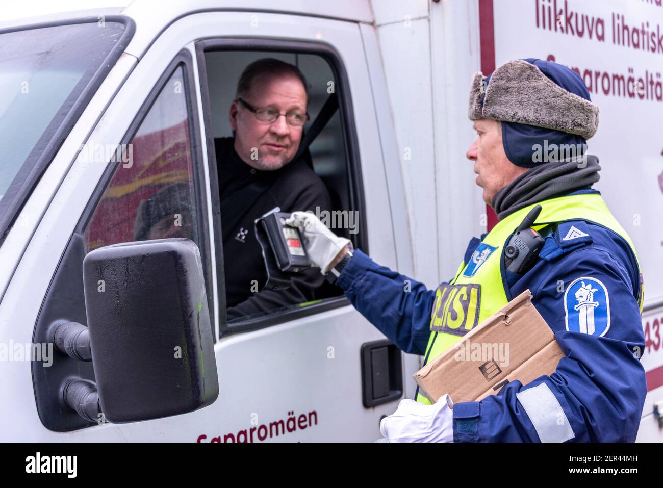 Finnish Police officers breathalysing drivers at random on a main road ...