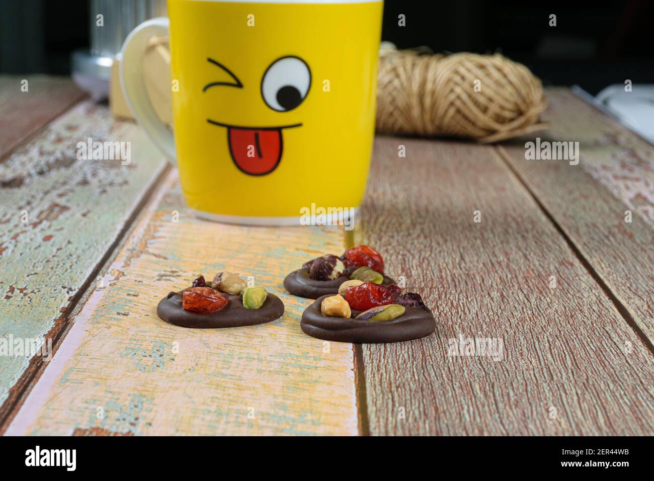 Three of chocolate chip cookies with nuts. In the background a yellow ...