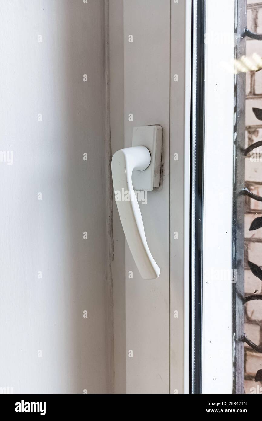 White window handle on a closed window Stock Photo - Alamy