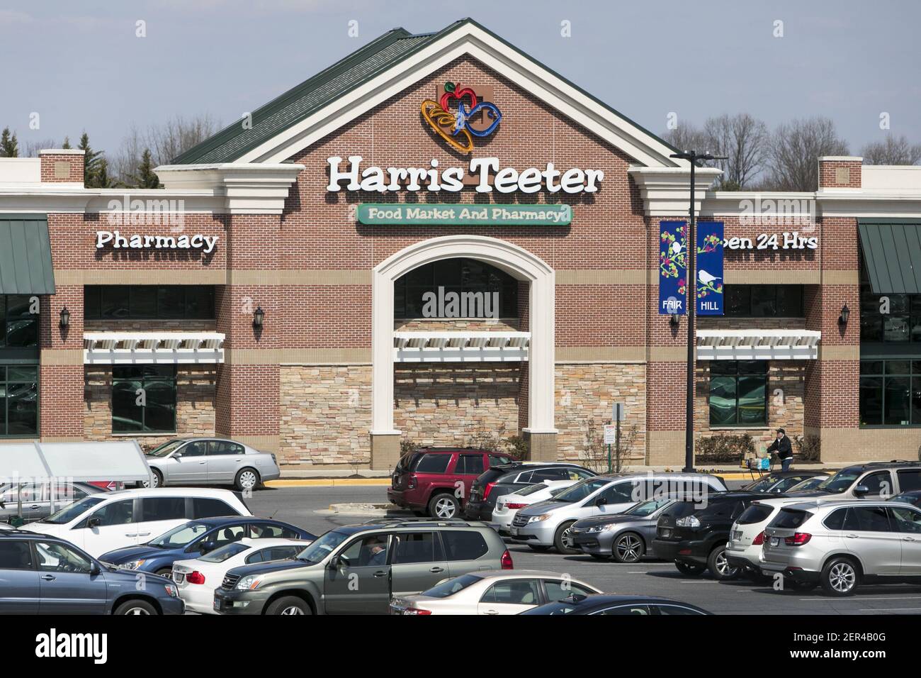 A logo sign outside of a Harris Teeter grocery retail store location in ...