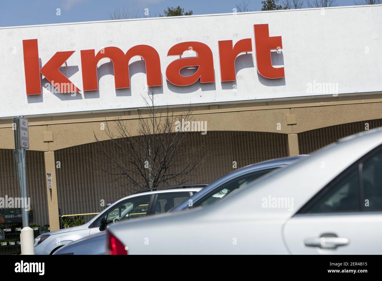 A logo sign outside of a Kmart retail store location in Silver Spring ...