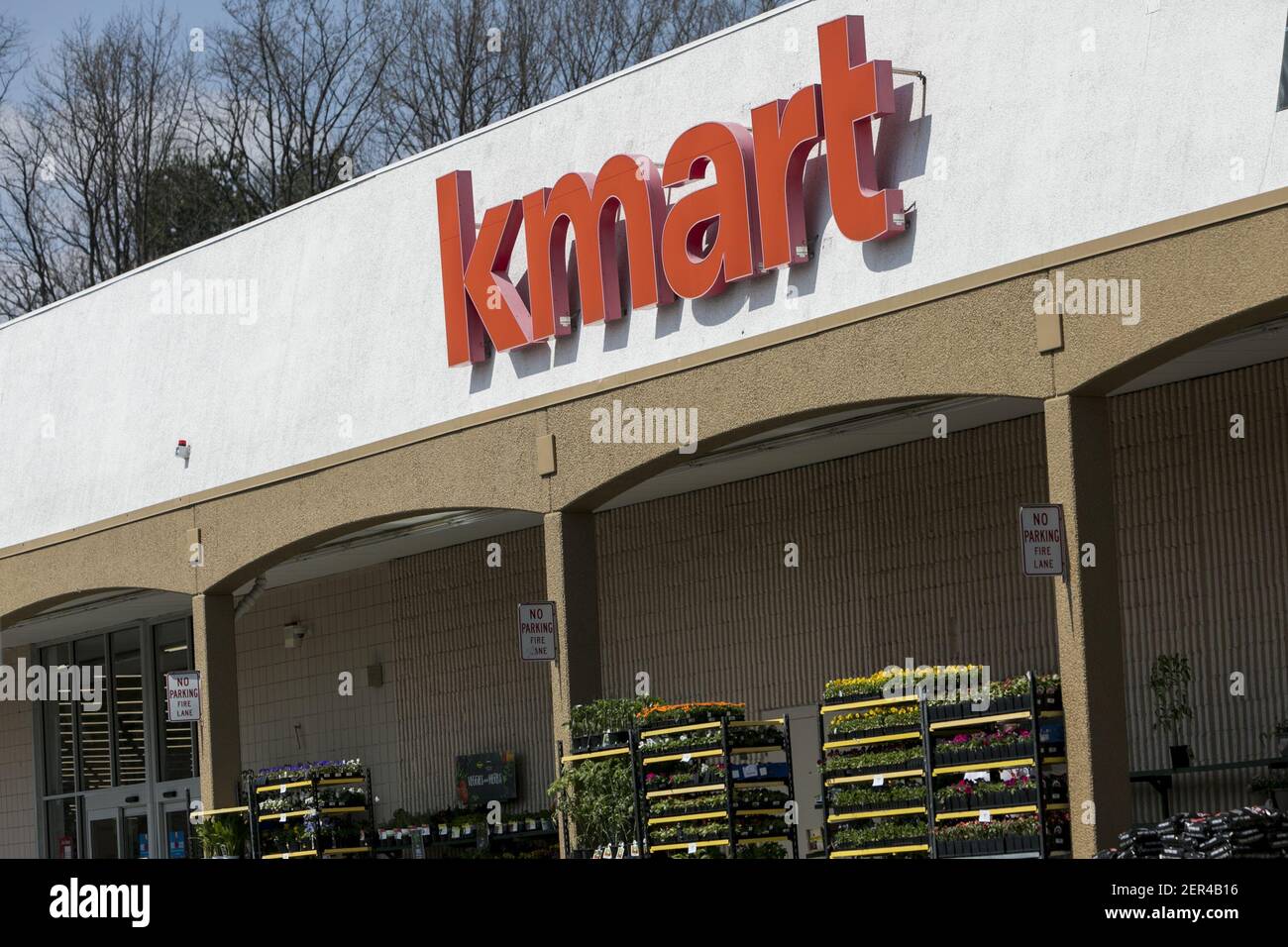 A logo sign outside of a Kmart retail store location in Silver Spring ...
