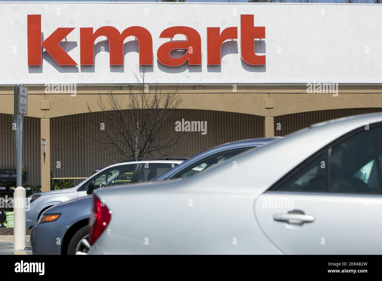 A logo sign outside of a Kmart retail store location in Silver Spring ...