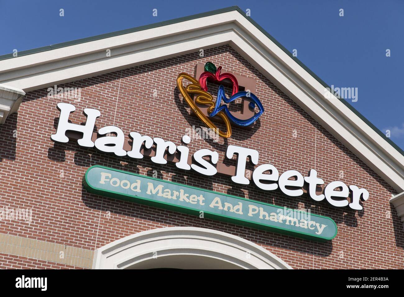 A logo sign outside of a Harris Teeter grocery retail store location in ...