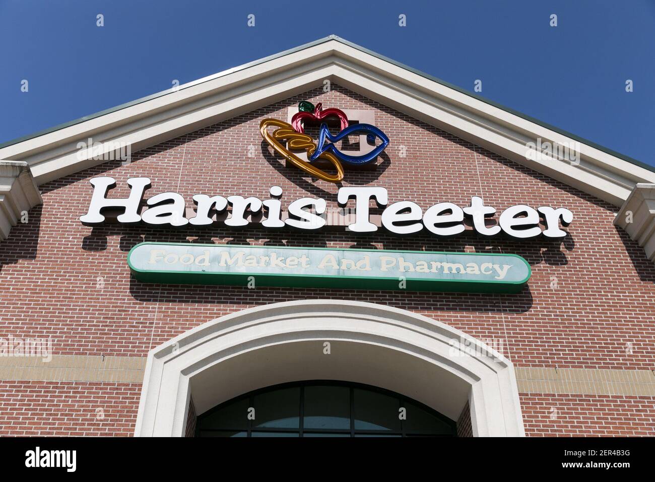 A logo sign outside of a Harris Teeter grocery retail store location in ...