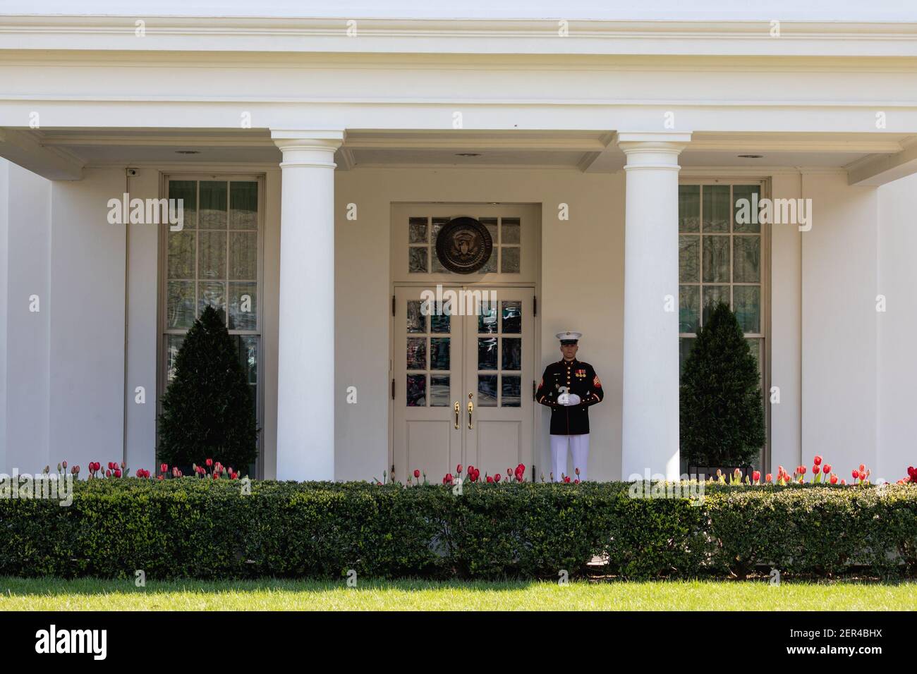 A U.S. Marine stands sentry over the West Wing of the White House in ...