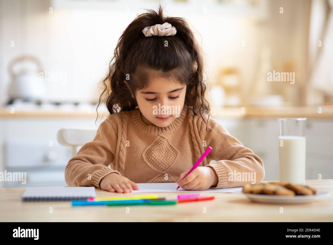 Portrait Of Adorable Little Girl Drawing With Pencils In Kitchen Stock ...