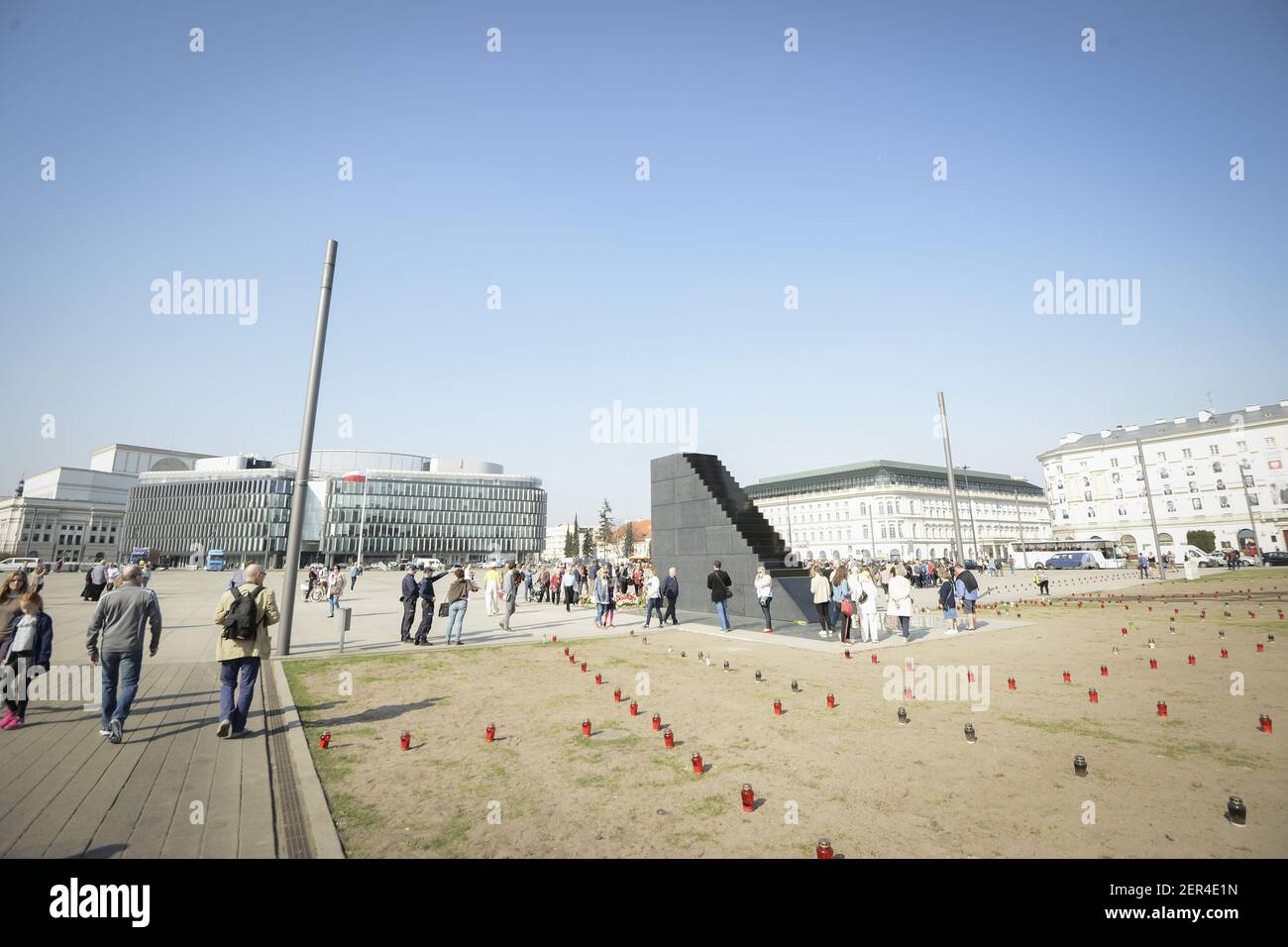People are seen visiting the Smolensk monument on Pilsudski Square in ...
