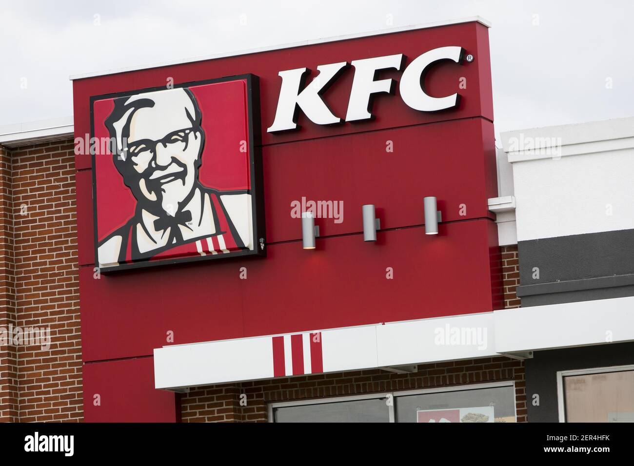 A logo sign outside of a KFC (Kentucky Fried Chicken) fast food ...