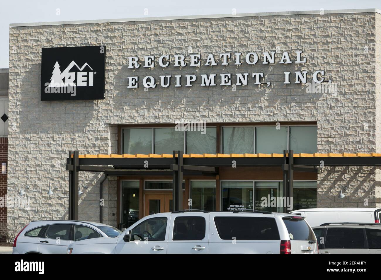 A logo sign outside of a Recreational Equipment, Inc., commonly known ...