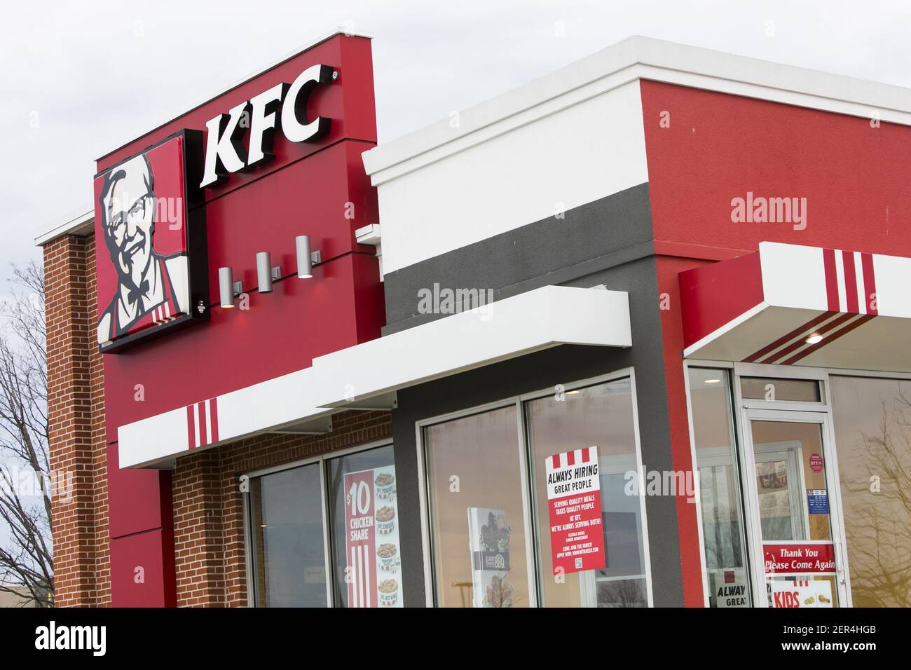 A logo sign outside of a KFC (Kentucky Fried Chicken) fast food ...